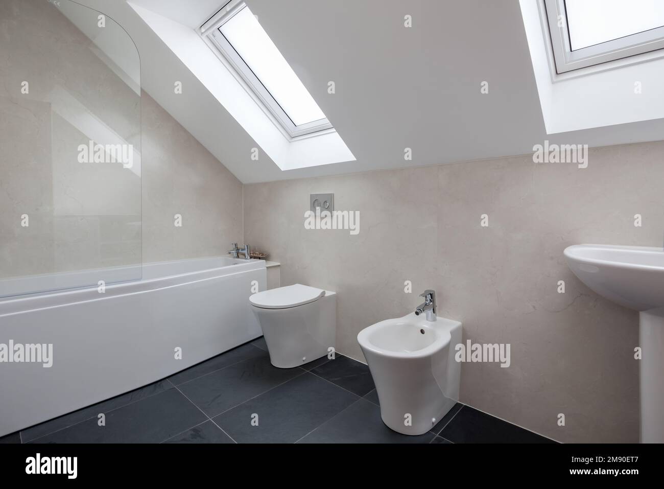 Contemporary modern attic style fitted bathroom with sloping ceiling ...