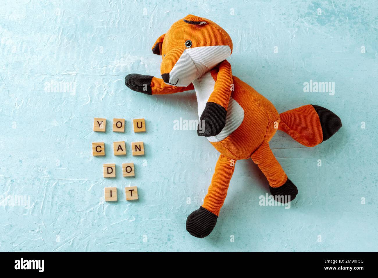 You can do it, motivational banner with a toy fox on a blue background ...