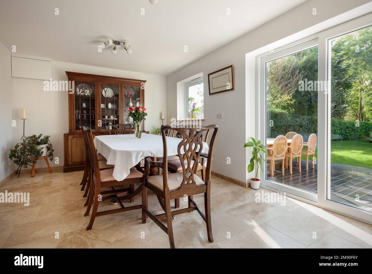 Sunlit dining room within modern house with traditional wooden ...