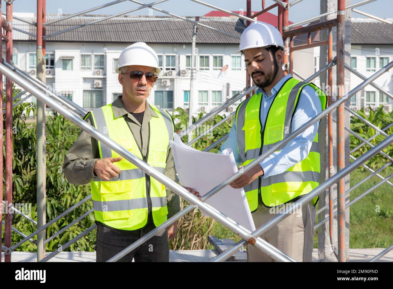 Two young architect discussion or contractor man while looking ...