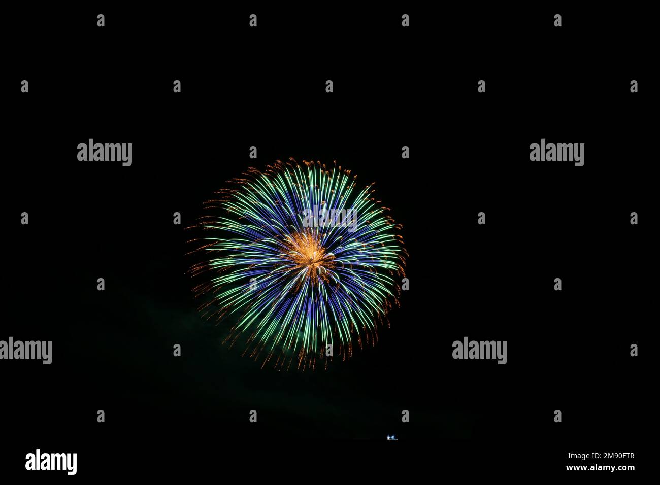 A eautiful festive background with bright green fireworks lighting up ...