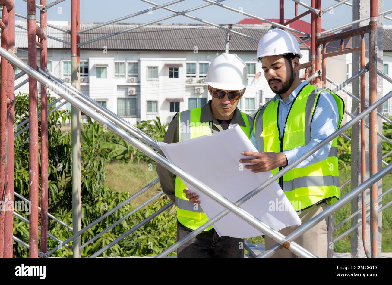 Two young architect discussion or contractor man while looking ...