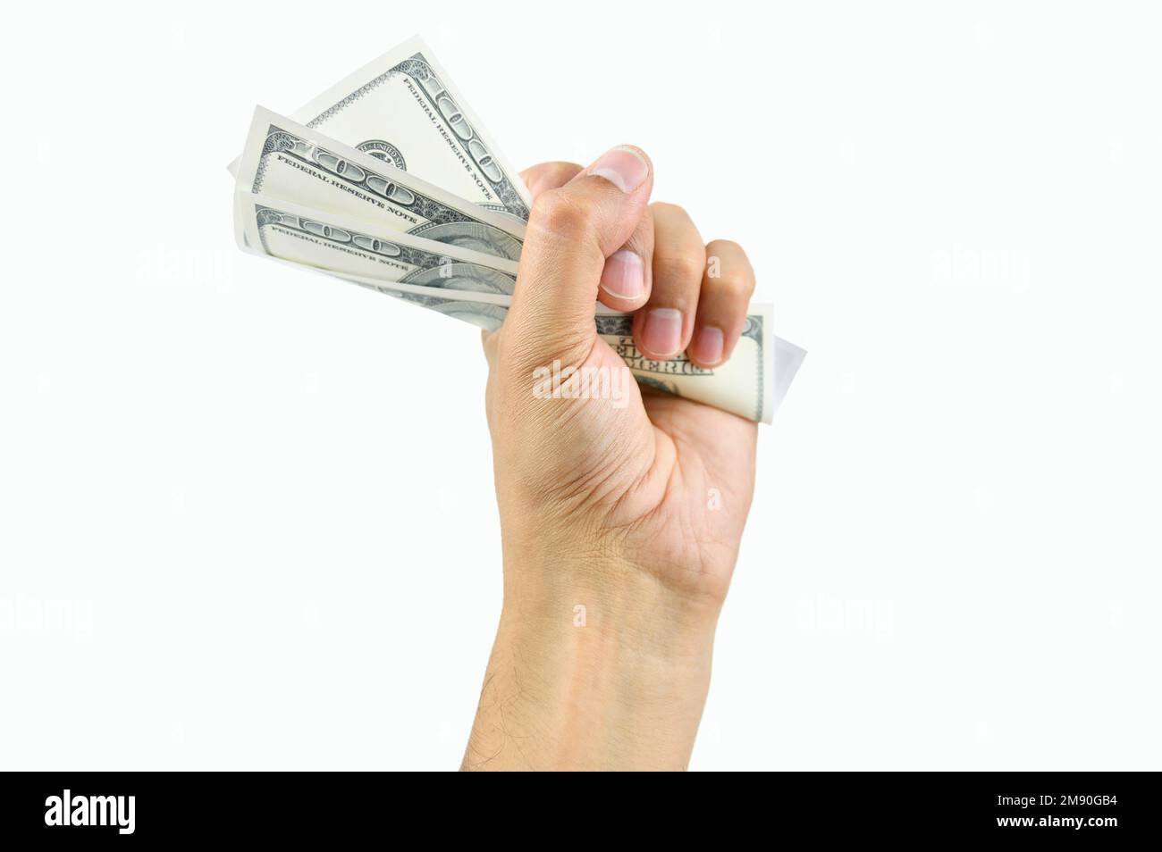 Closeup of a man's hand crushing a wad of hundred dollar notes while ...