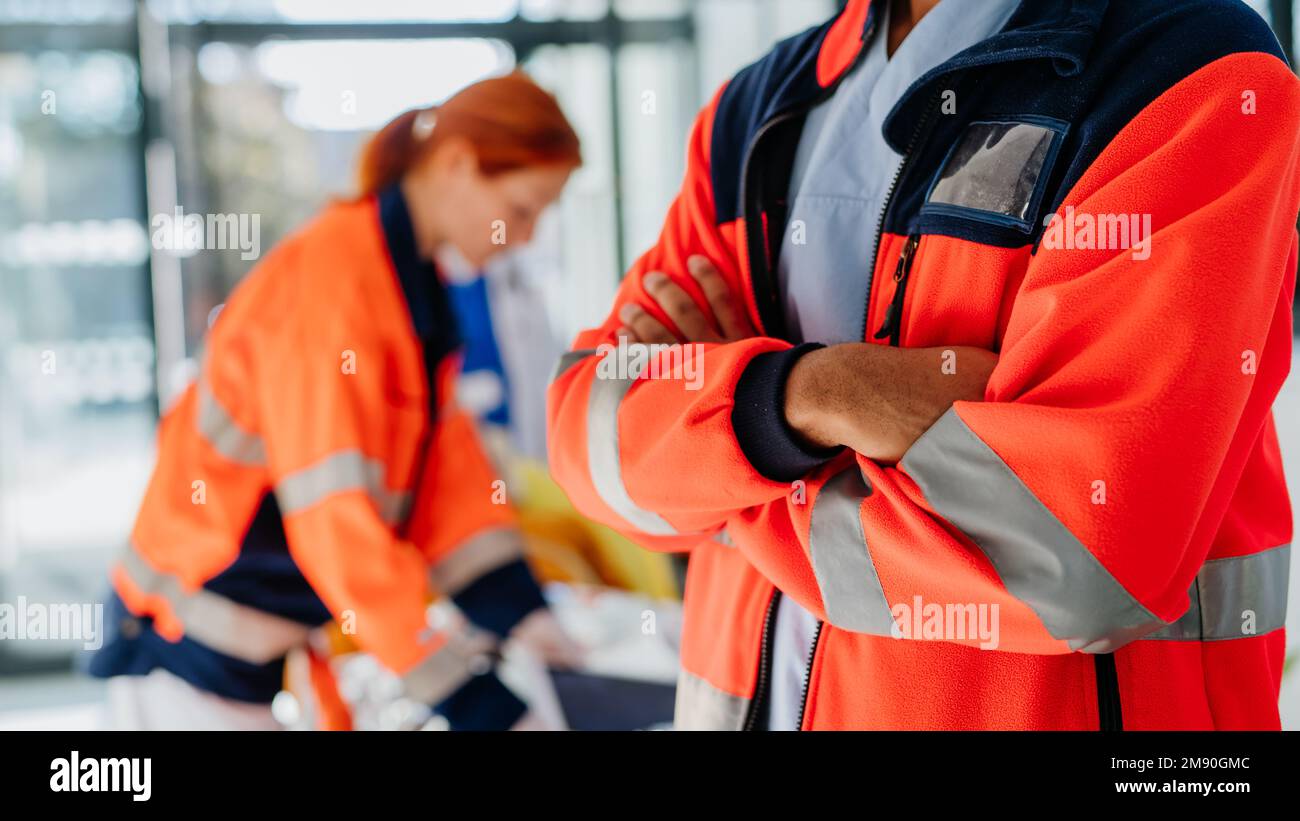 Close-up of rescuer man, his colleagues taking care of patient from an ...