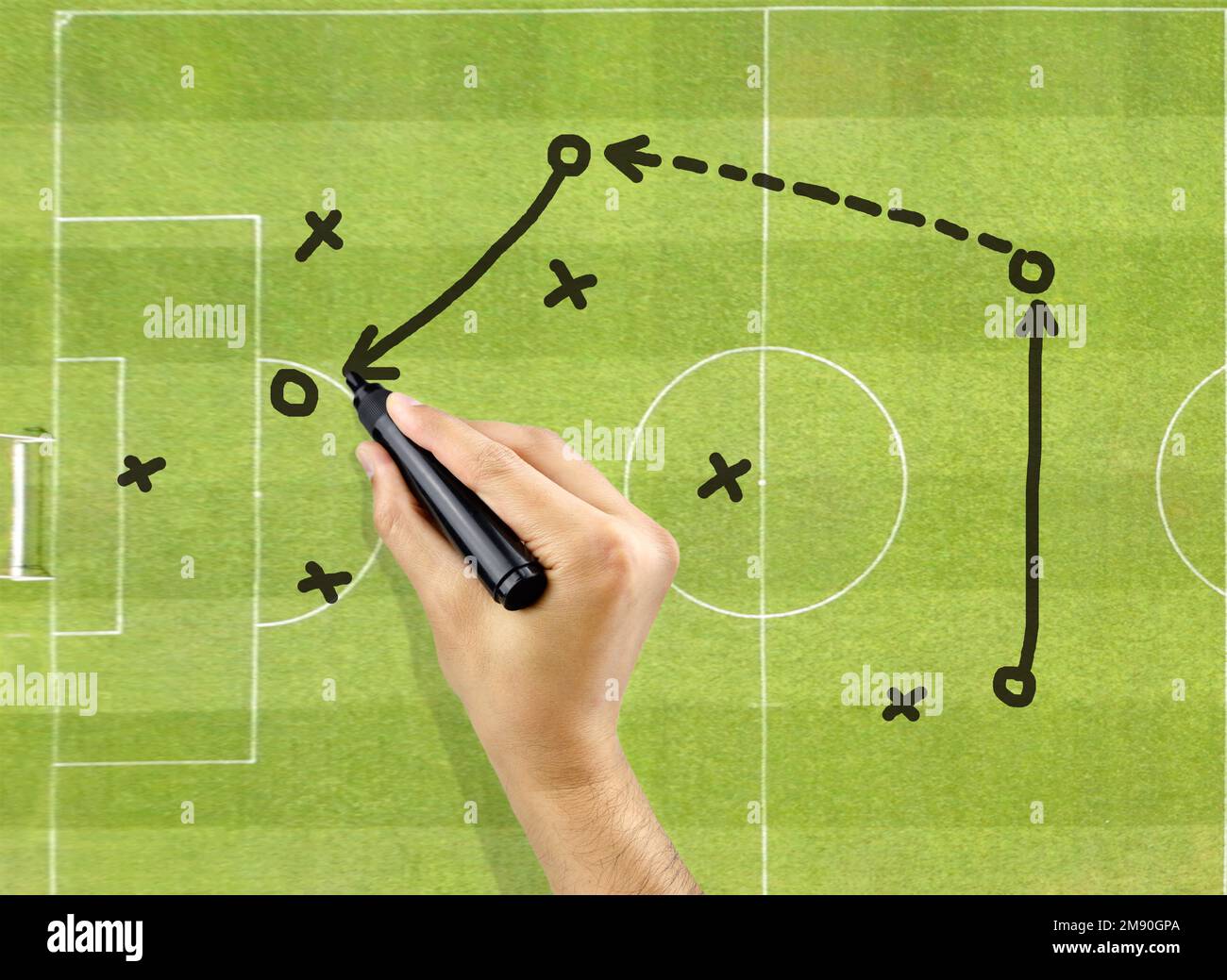 hand of a football coach drawing a tactics of soccer game with black ...