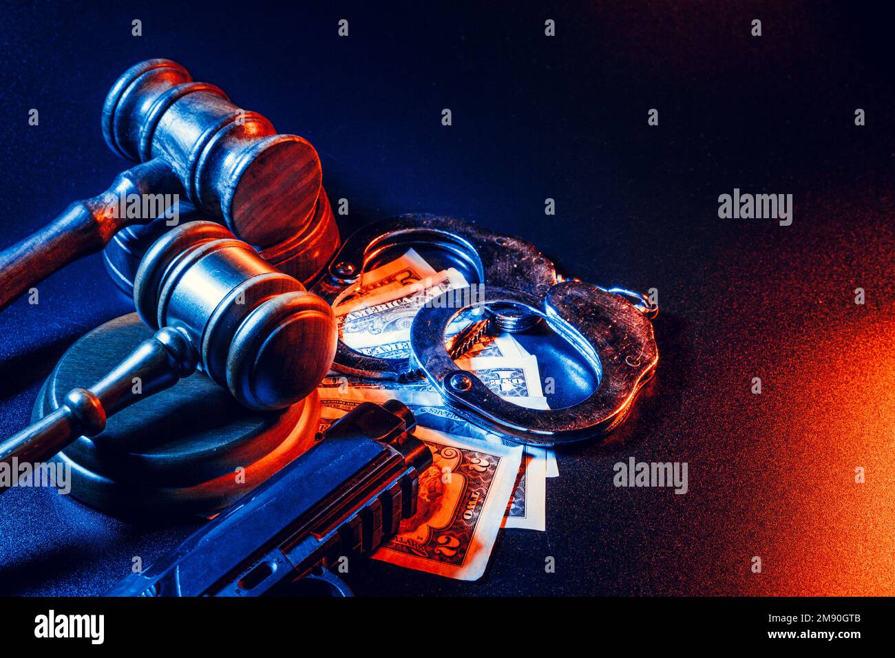 Gun and judge's gavel on the table. Crime, robbery, attack concept ...