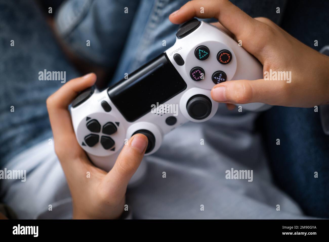 kids hands with joystick, child playing video game console while ...