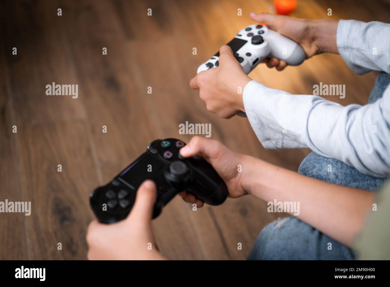 kids hands with joysticks, two children siblings playing video game ...