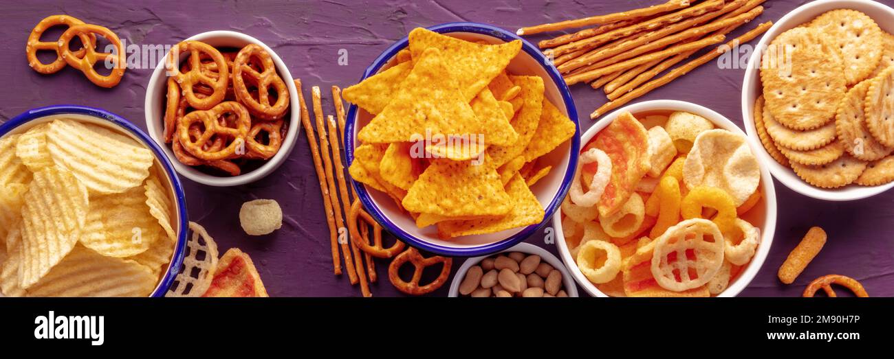 Salty snacks panorama. Party food panoramic banner. Assorted appetizers ...