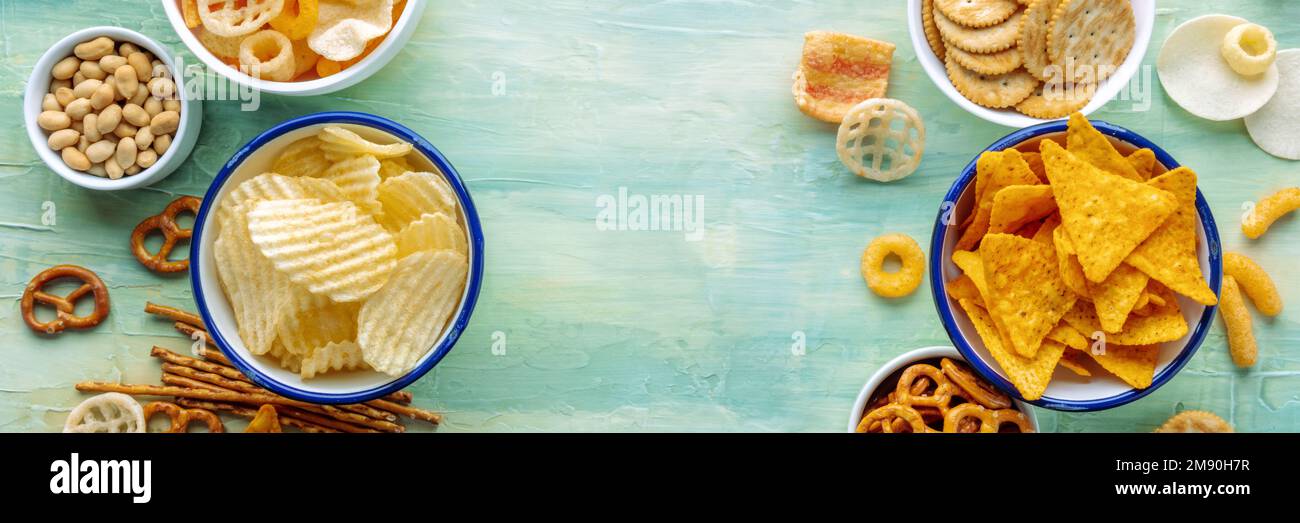 Salty snacks panorama, overhead flat lay background with copy space ...