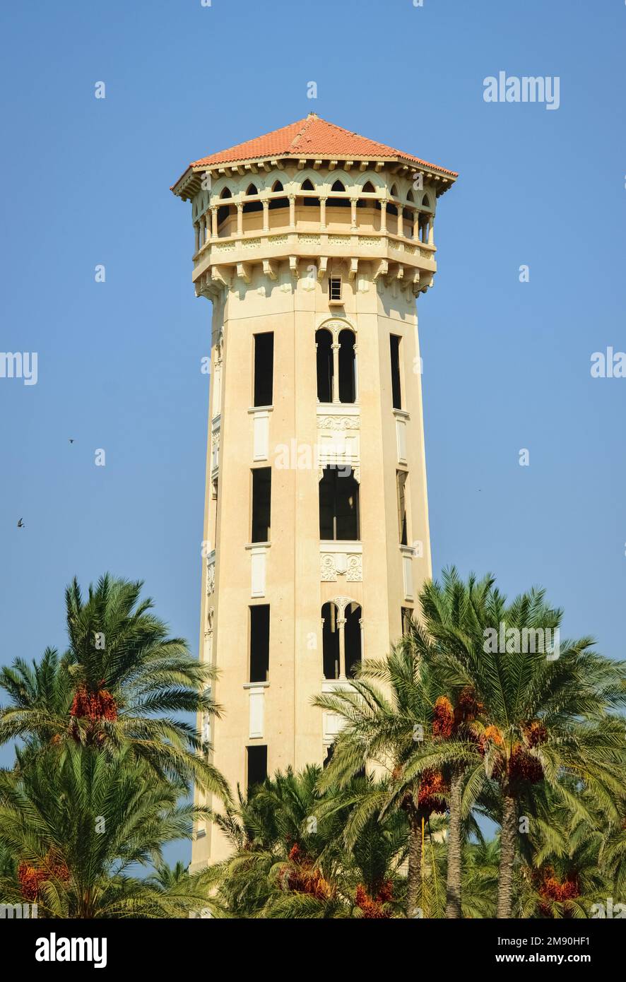 The Montaza Palace surrounded by palm trees on a sunny day in ...