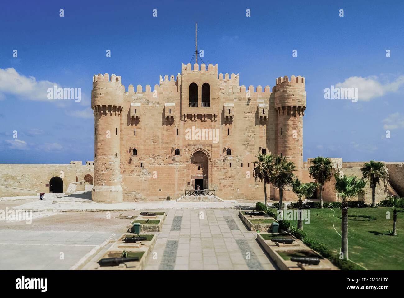 The Museu Qaitbey surrounded by a garden under a blue cloudy sky in ...