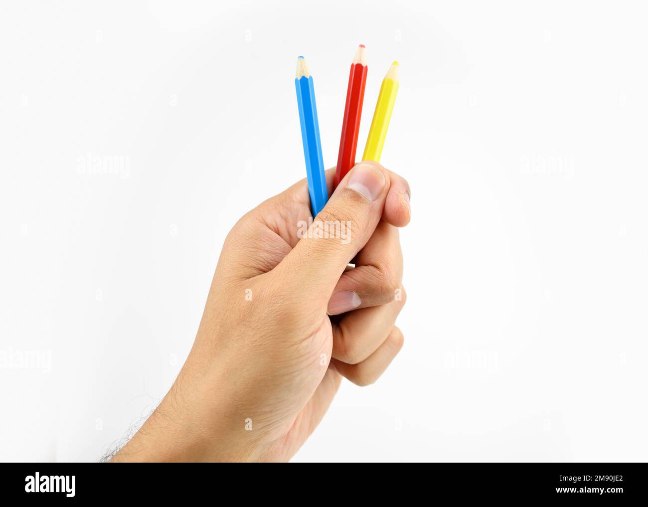 Hand holding a pencil against blue background with vignette Stock Photo ...