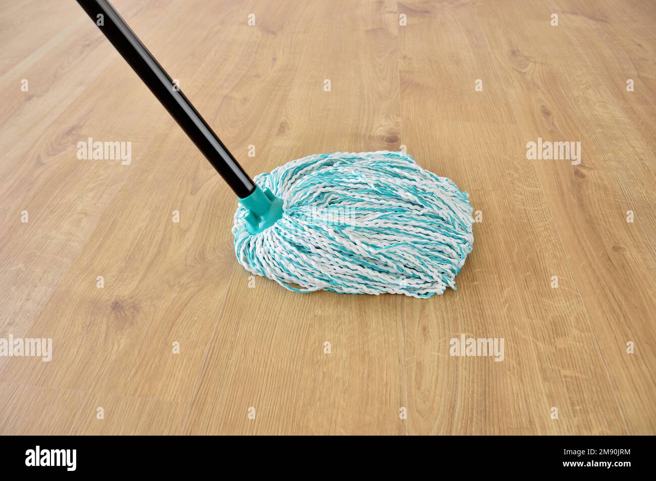 cleaning gear mopping a living room floor with parquet Stock Photo - Alamy