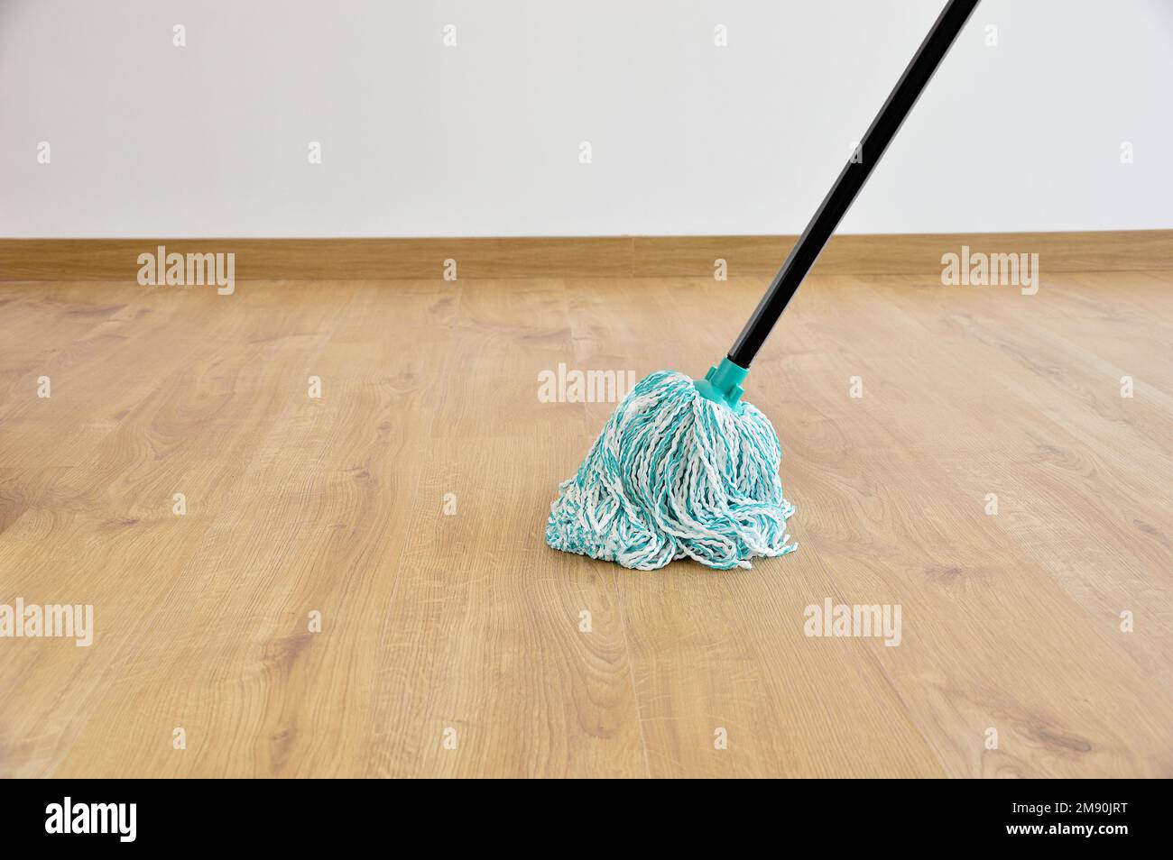 cleaning gear mopping a living room floor with parquet Stock Photo - Alamy