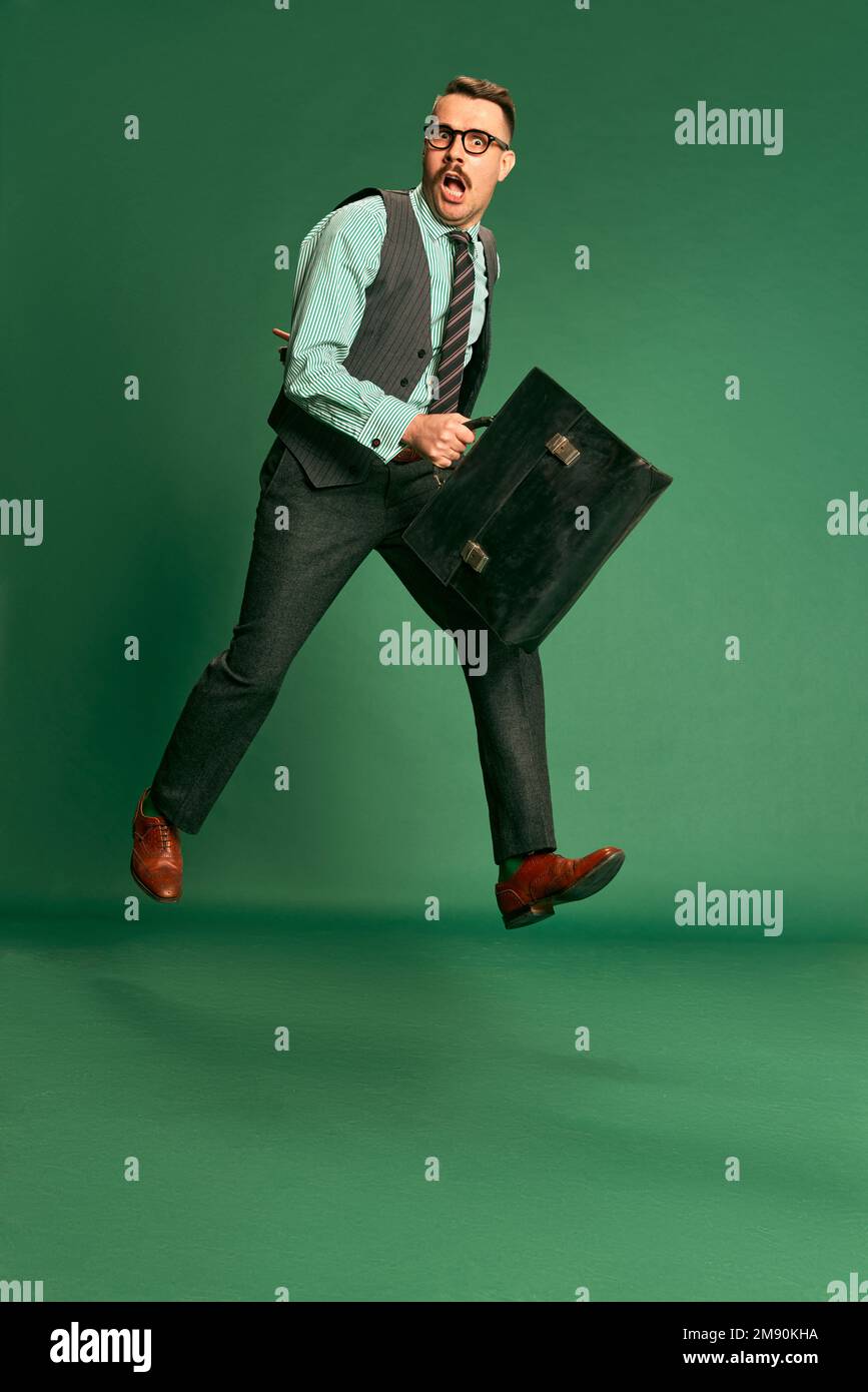 Running to work. Portrait of handsome man, businessman in classical ...