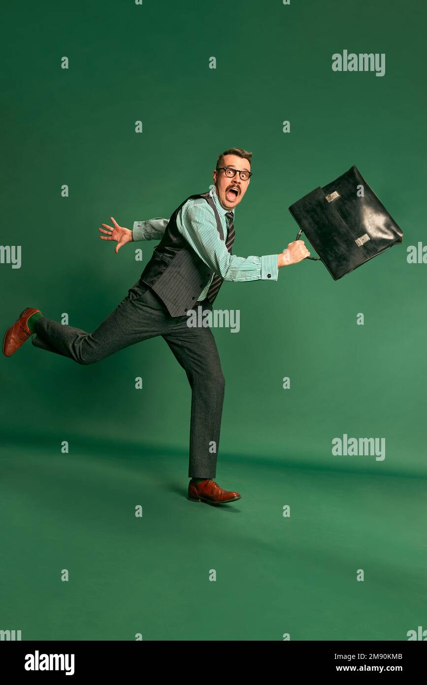Portrait of handsome man, businessman in classical suit with briefcase ...