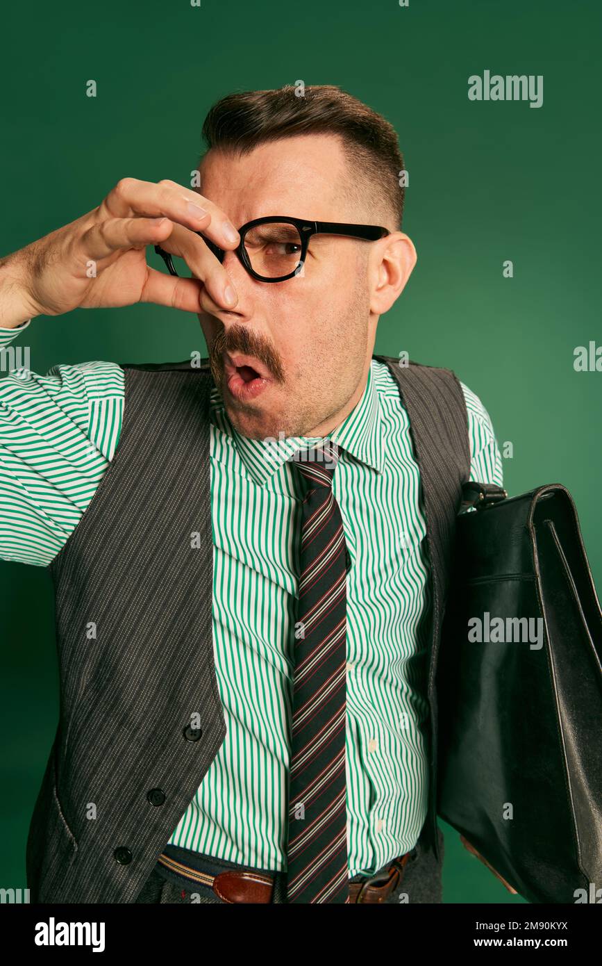 Bad smell. Portrait of handsome man, businessman in classical suit ...