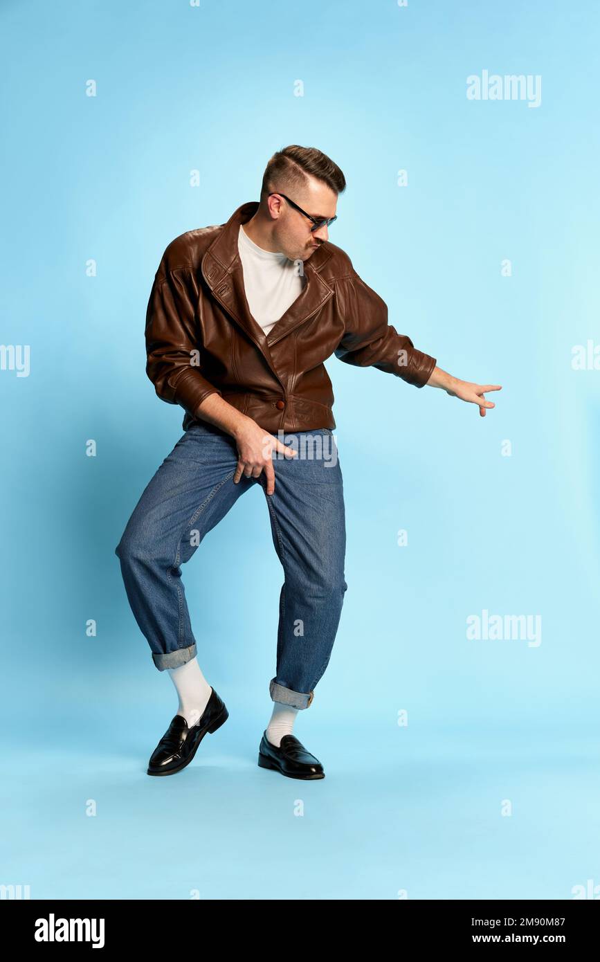 Self-expression. Portrait of brutal, handsome man in jeans, leather ...