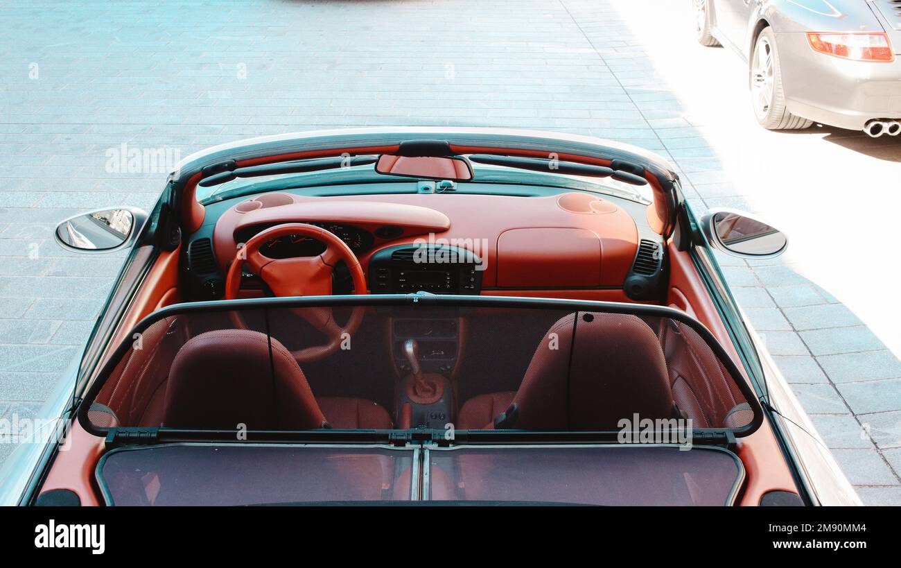 A red car interior with a roof down Stock Photo - Alamy