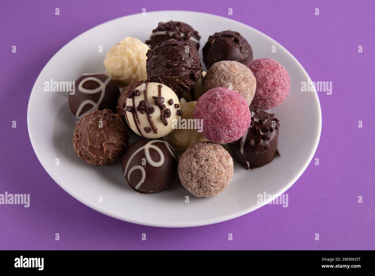 photo of round-shaped candies with different decorations lying on a ...