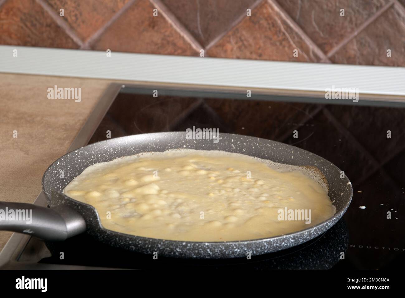 photo pan standing on a stove, it is used to fry batter for thin ...