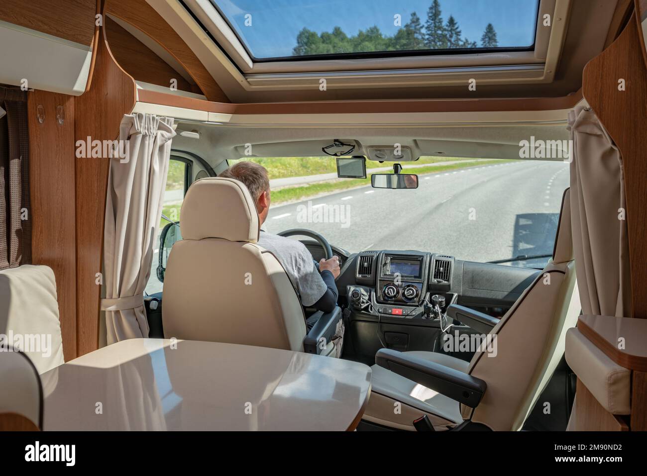 Man driving on a road in the Camper Van RV. Caravan car Vacation ...