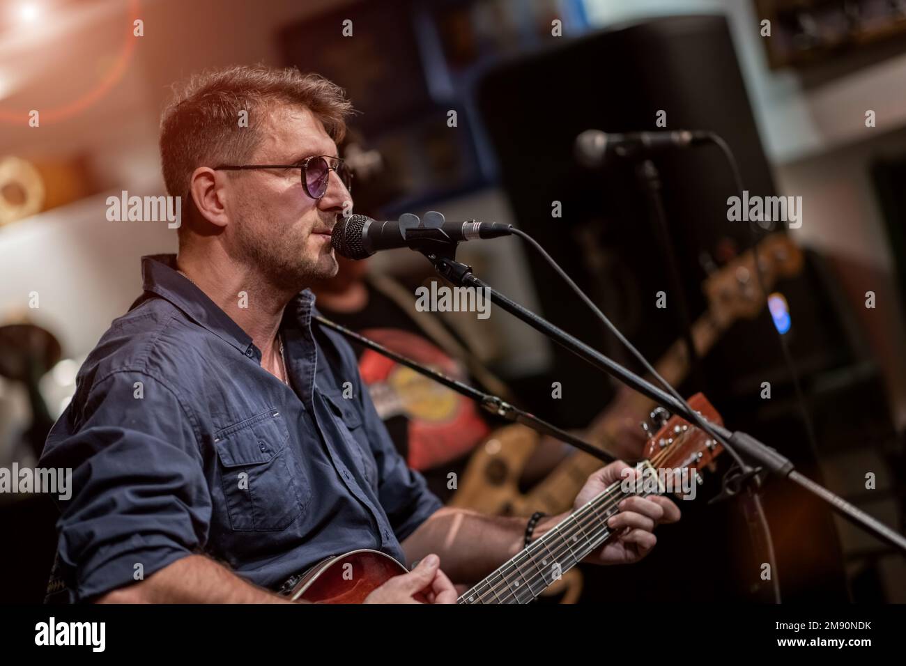 Band performs on stage, rock music concert. Warning - authentic ...