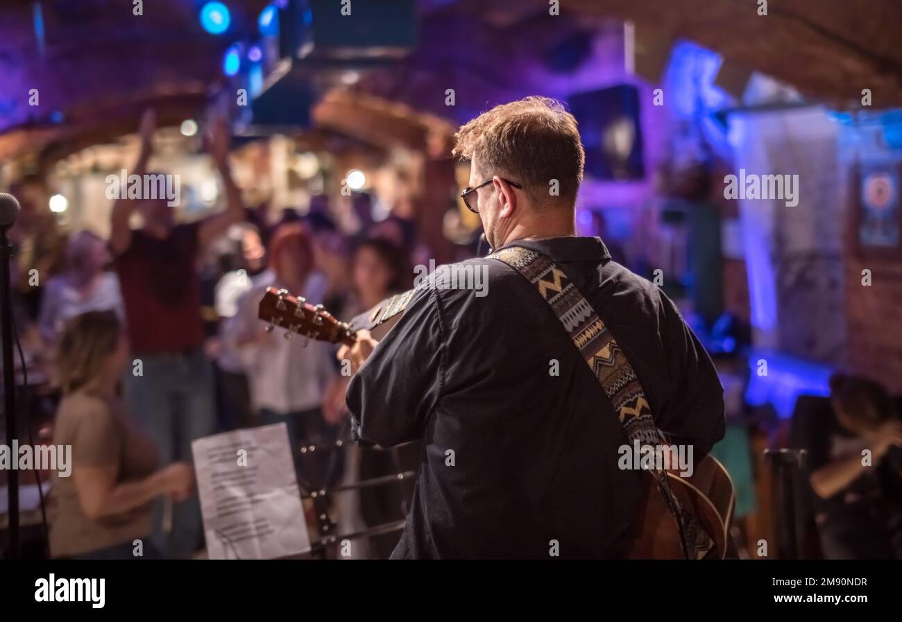 Band performs on stage, rock music concert. Warning - authentic ...