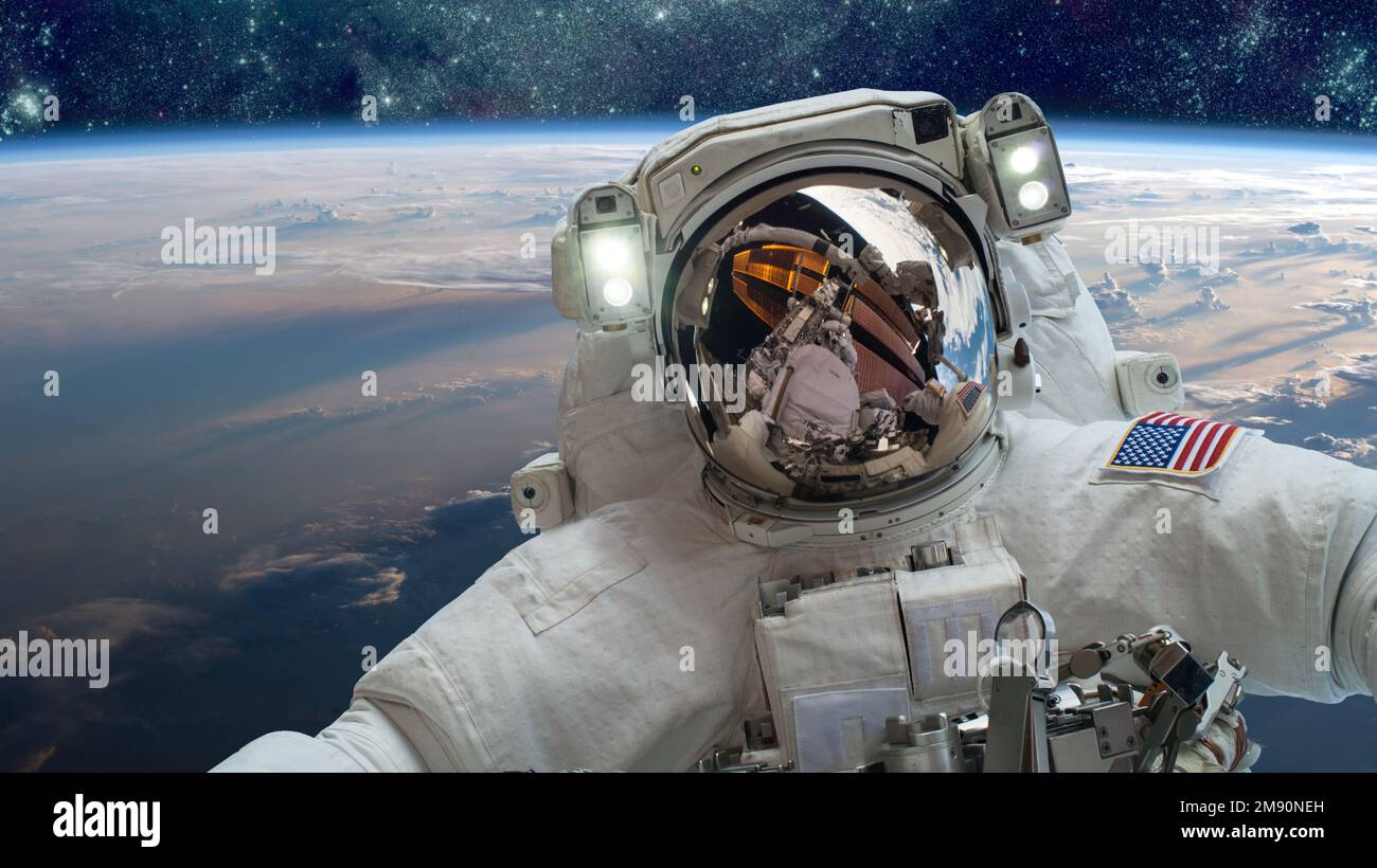 Astronaut in outer space against the backdrop of the planet earth ...