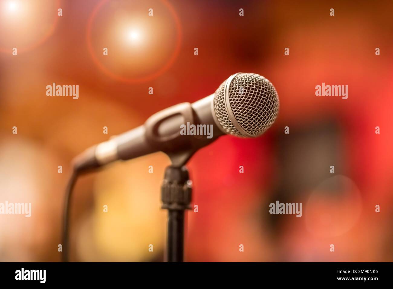 Public performance on stage Microphone on stage against a background of ...