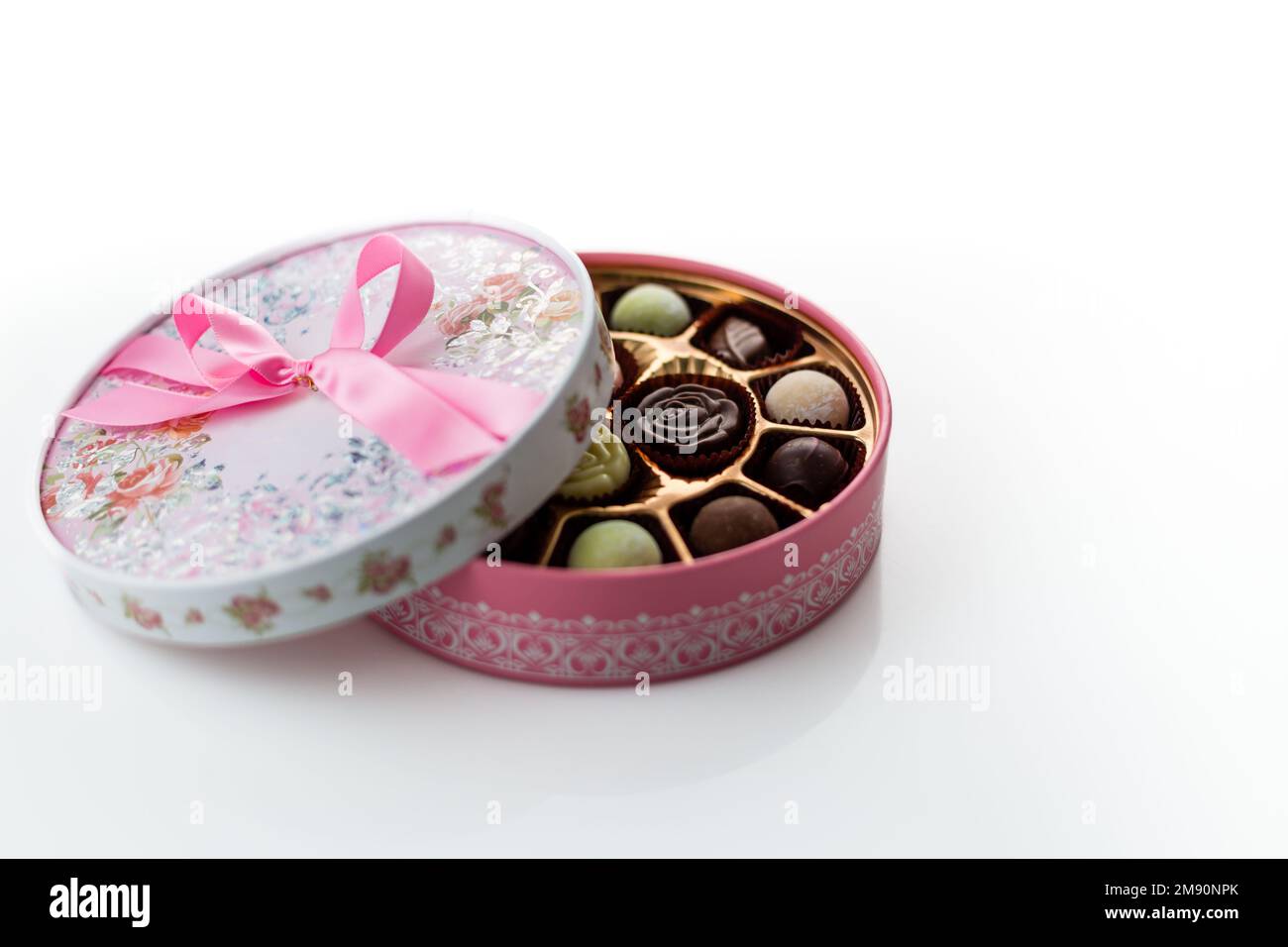 Pink box of chocolates with ribbon bow Stock Photo - Alamy