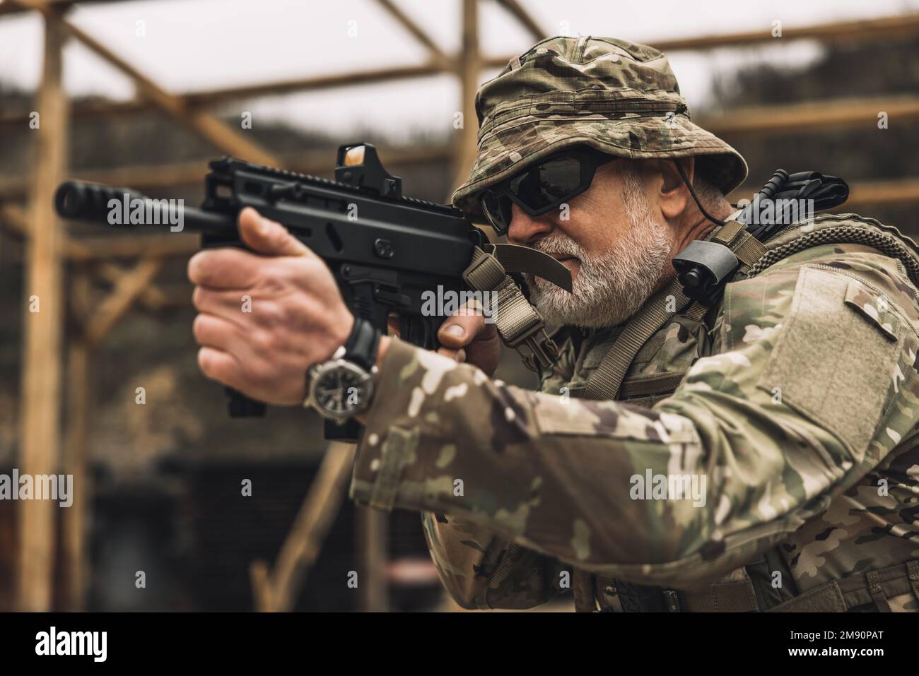 Mature soldier with a rifle in hands on a shooting range Stock Photo ...