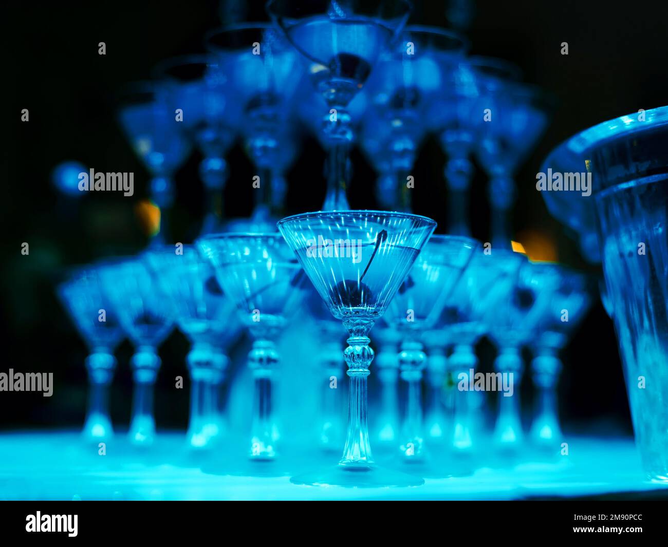 tower of cocktail glasses for the bartender show closeup with blue ...
