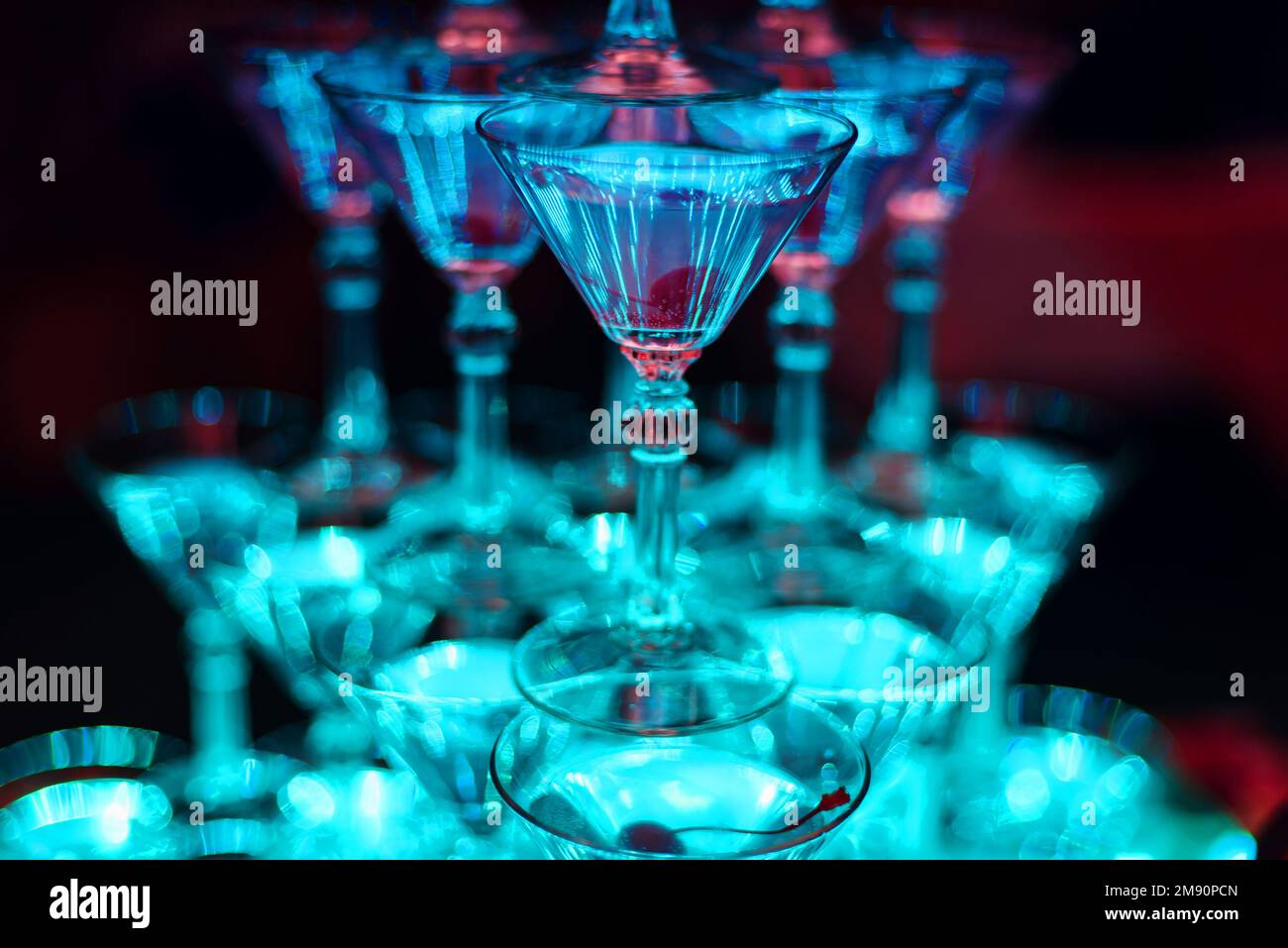 glasses Martini cocktail with cherry close-up with multi-colored ...