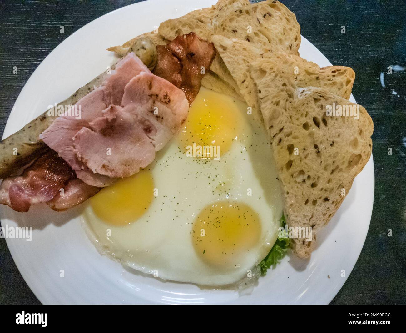 Ham, egg, bacon, German sausage and toast brunch Stock Photo - Alamy