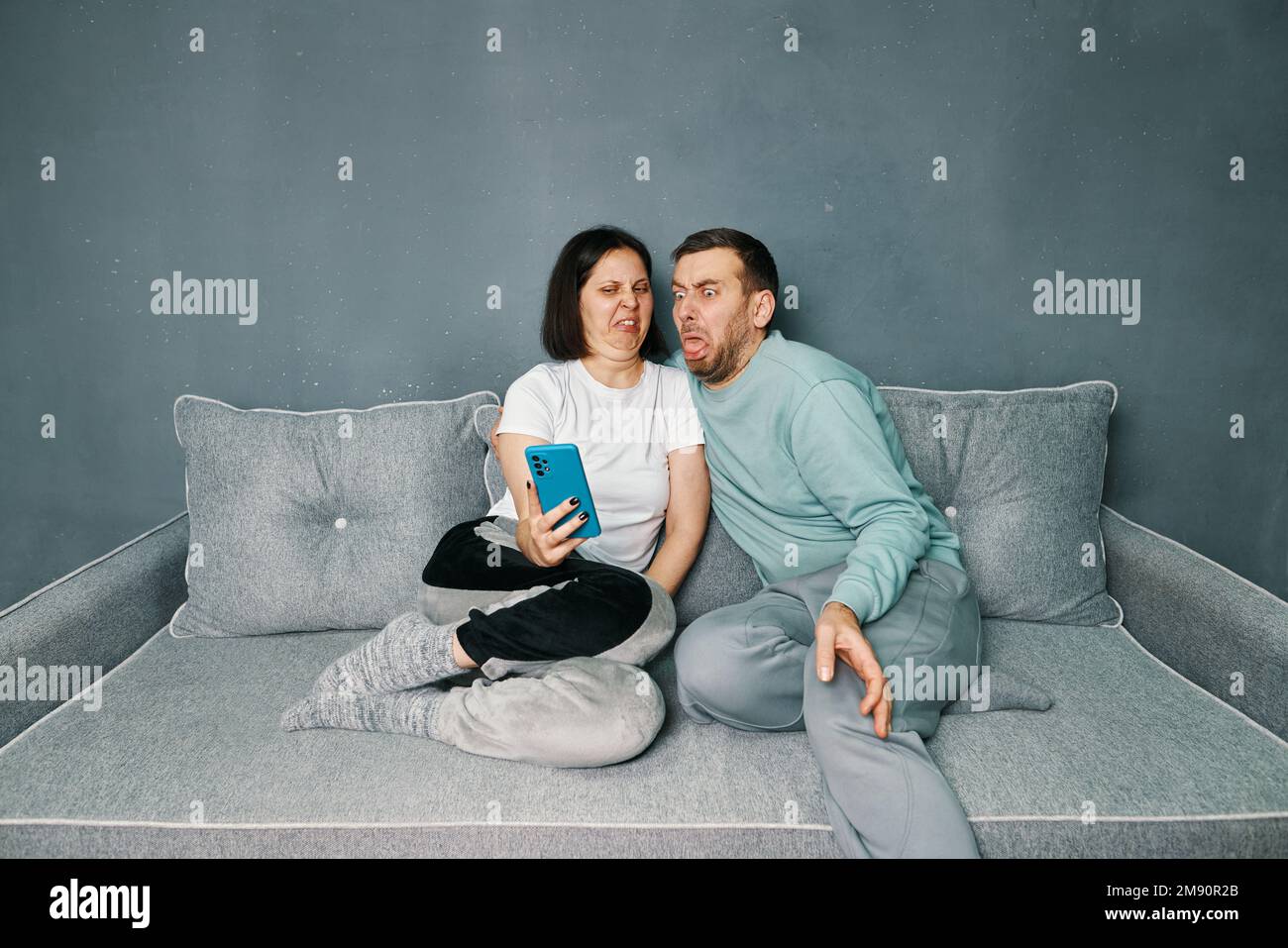 Millennial couple with disgust face expression because aversion ...