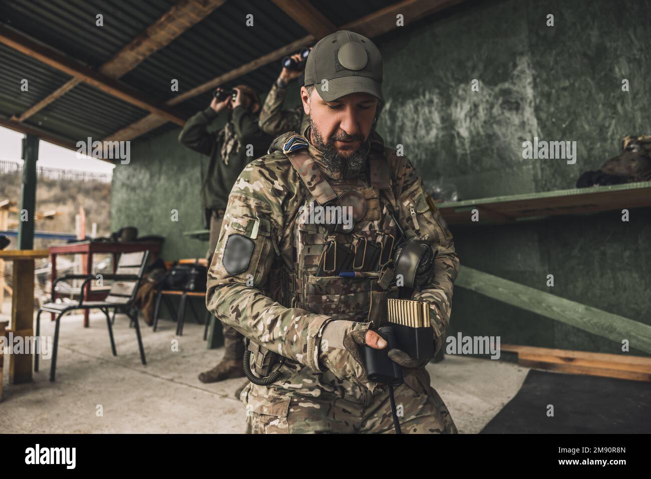 Serious soldier in camouflage with an optical rifle Stock Photo - Alamy