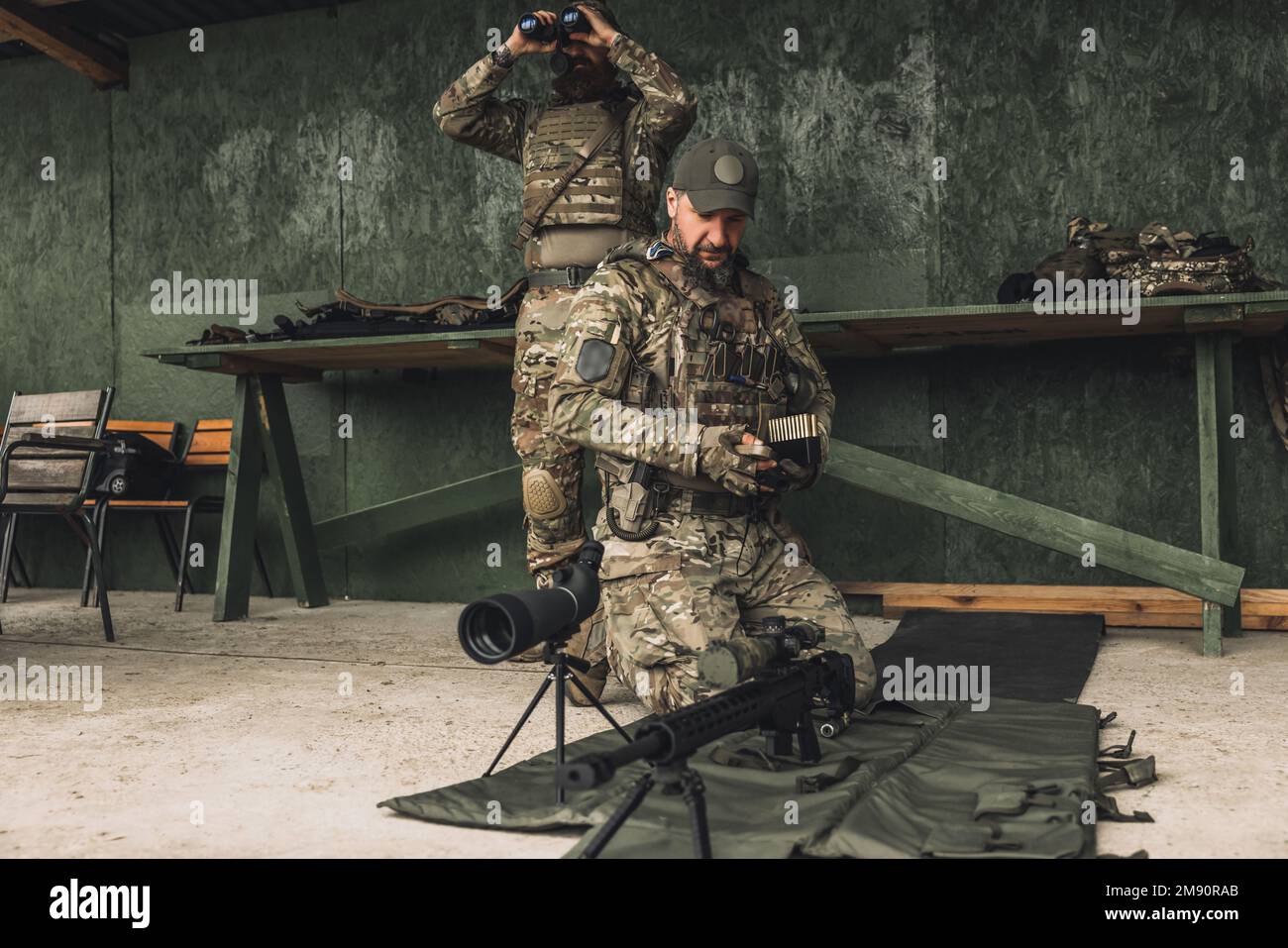 Serious soldier in camouflage with an optical rifle Stock Photo - Alamy