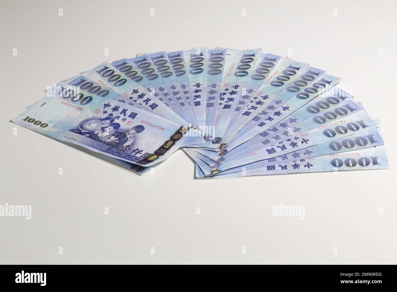 NT dollars in a fan on white background Stock Photo - Alamy