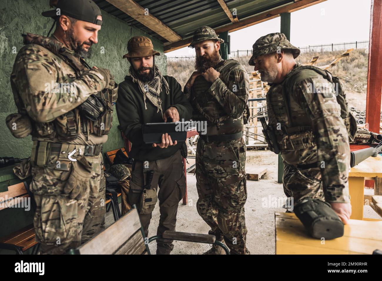 Group of soldiers discussing something before combat Stock Photo - Alamy