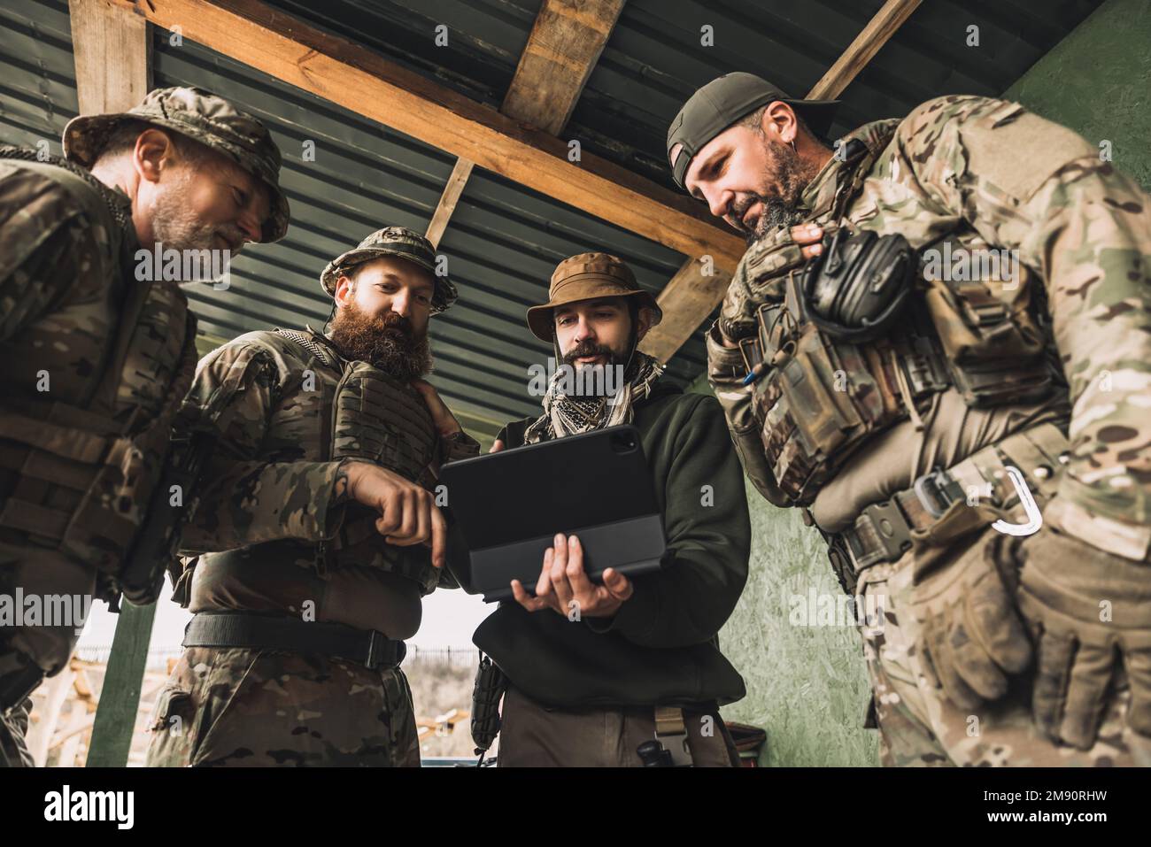 Group of soldiers discussing something before combat Stock Photo - Alamy