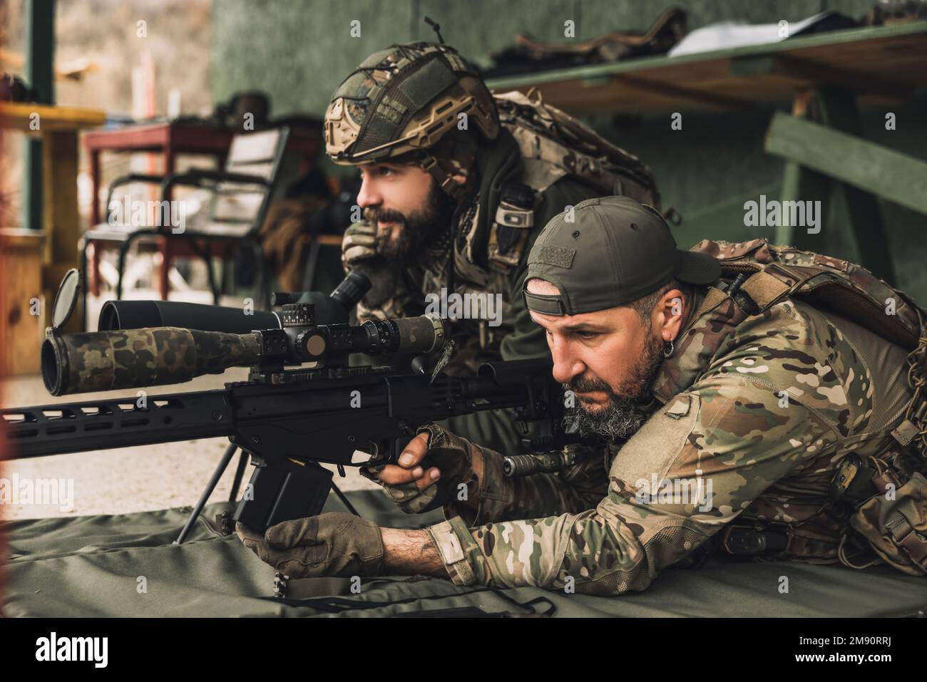 Soldier in camouflage preparing the rifle for shooting Stock Photo - Alamy