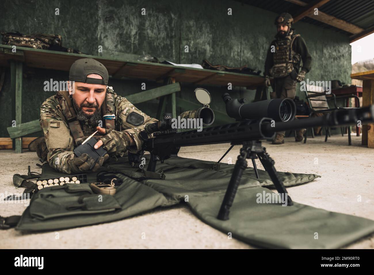 Soldier in camouflage preparing the rifle for shooting Stock Photo - Alamy