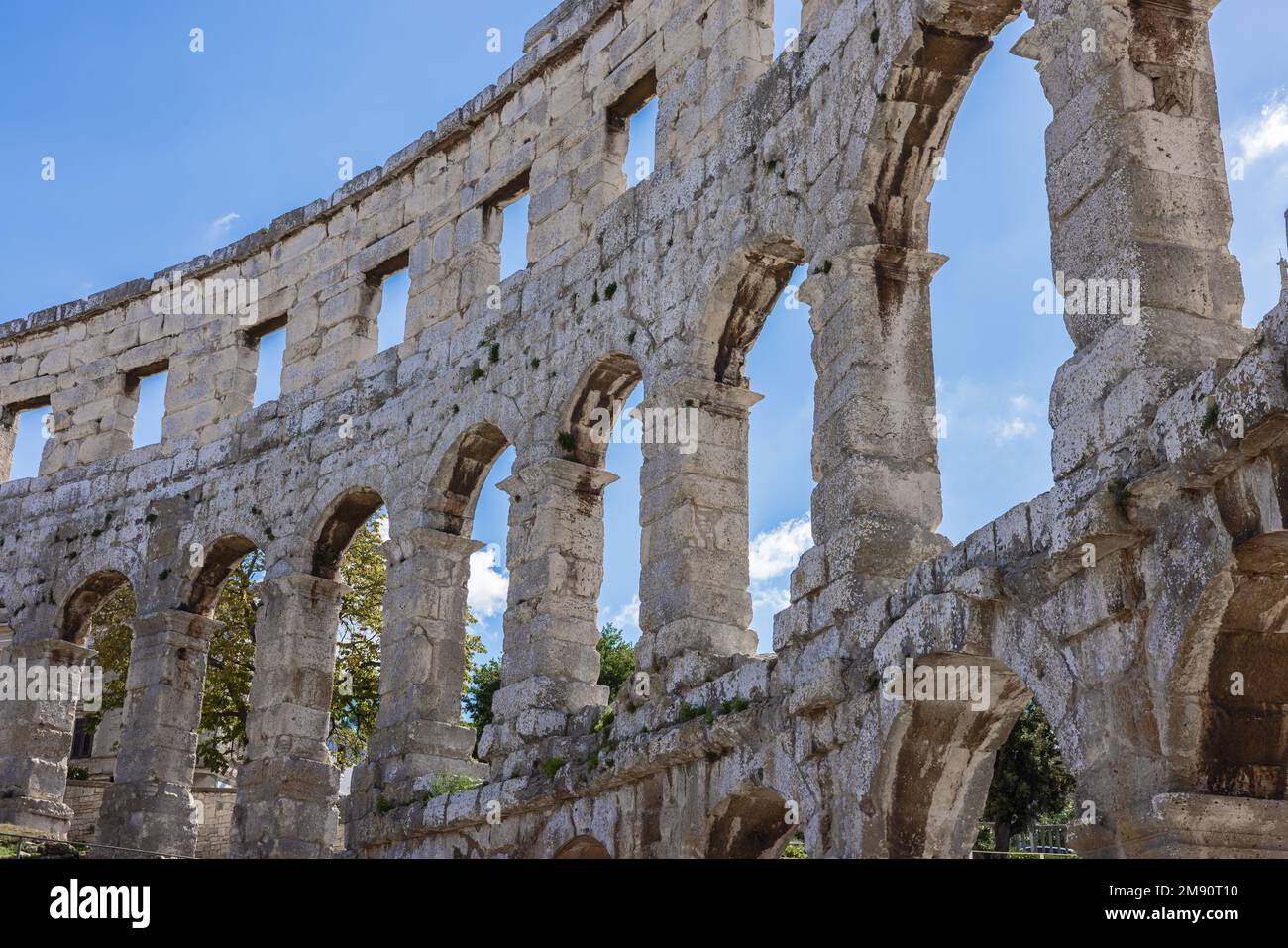 Looking up at walls of the amphitheater in Pula seen from the backstage ...