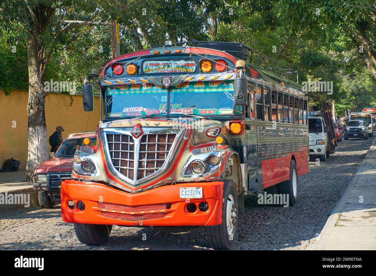Colorful chicken bus running on the main street of Antigua Guatemala ...