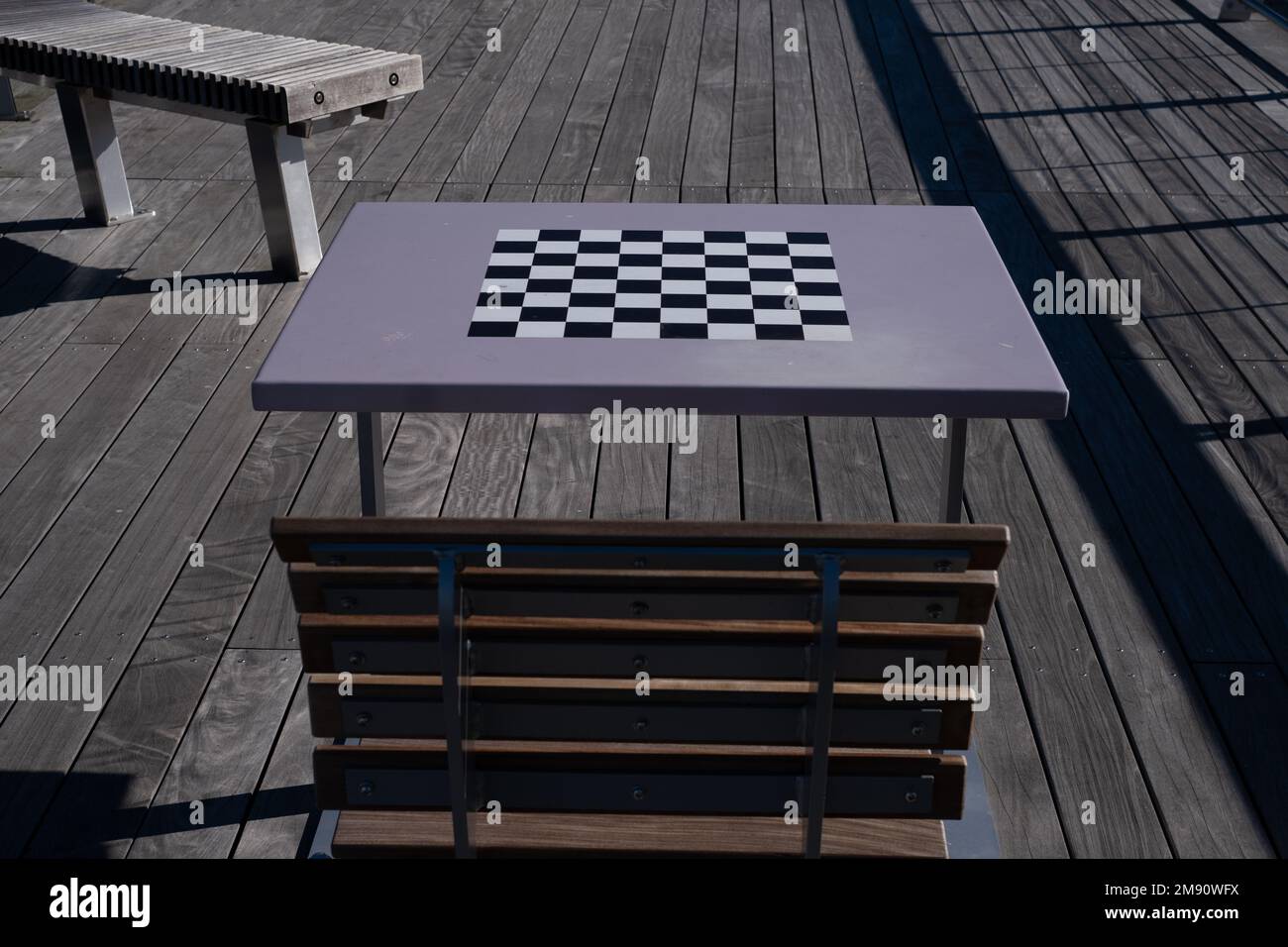a game table with a chess pattern and benches outdoors Stock Photo - Alamy