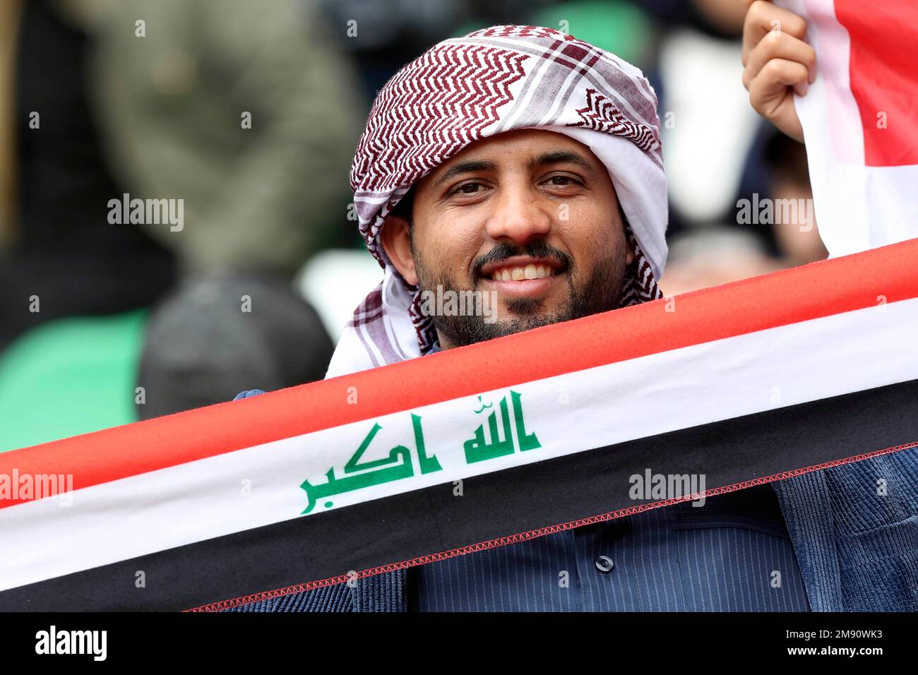 An Iraqi supporter holds up a national flag inside the stadium before ...