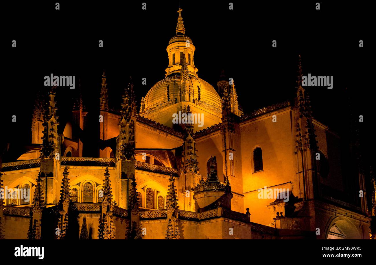 A bottom up landscape view of a lit Segovia Cathedral at night in Spain ...