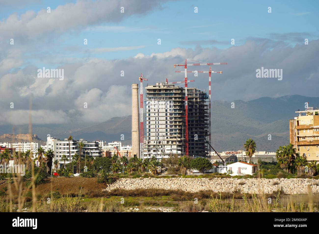 High-rise buildings, tower block, surrounded by cranes in Malaga under ...
